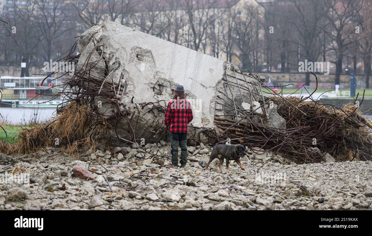 Dresden, Germany. 02nd Jan, 2025. A man stands on the banks of the Elbe ...