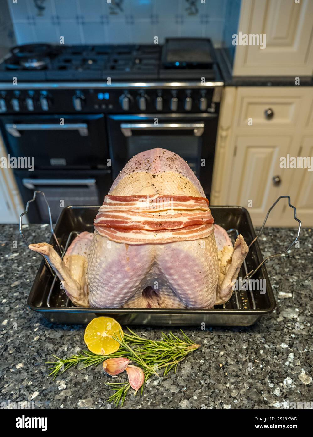 A turkey crown in a roasting tin on a kitchen counter ready for cooking ...