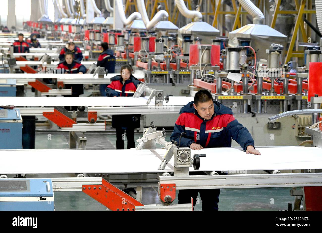 Workers labor at a plant of polyvinyl chloride (PVC) foam boards in ...