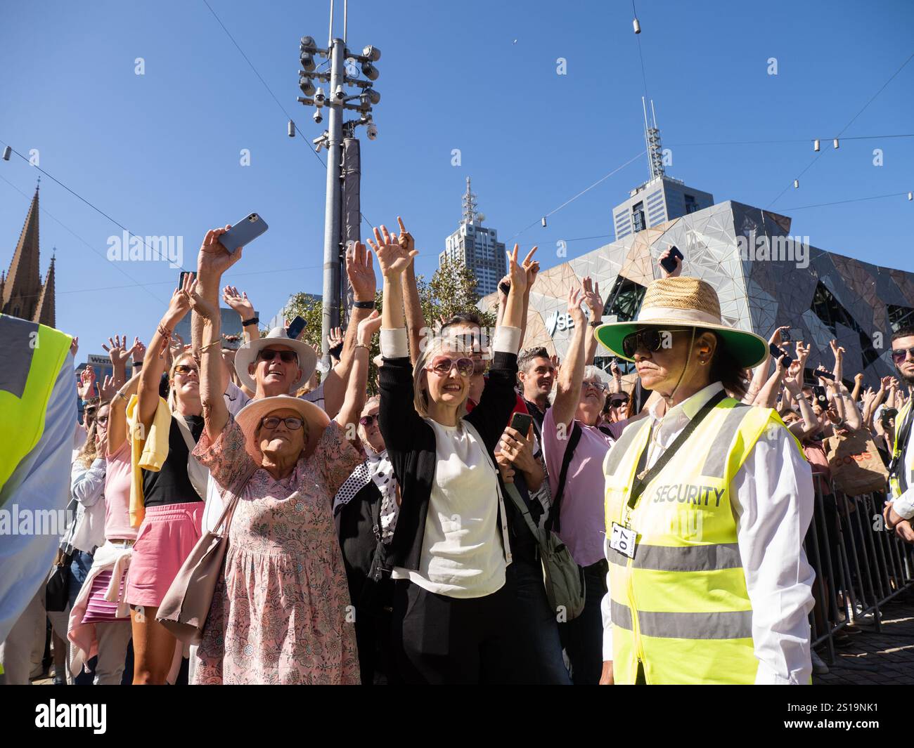 Fans raise their arms in cheering for Williams. Robbie Williams ...