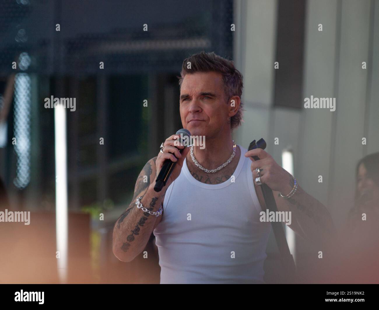 Williams is seen on stage. Robbie Williams performs a public concert to ...