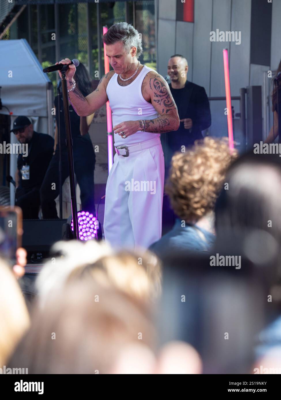 Williams is seen on stage. Robbie Williams performs a public concert to ...
