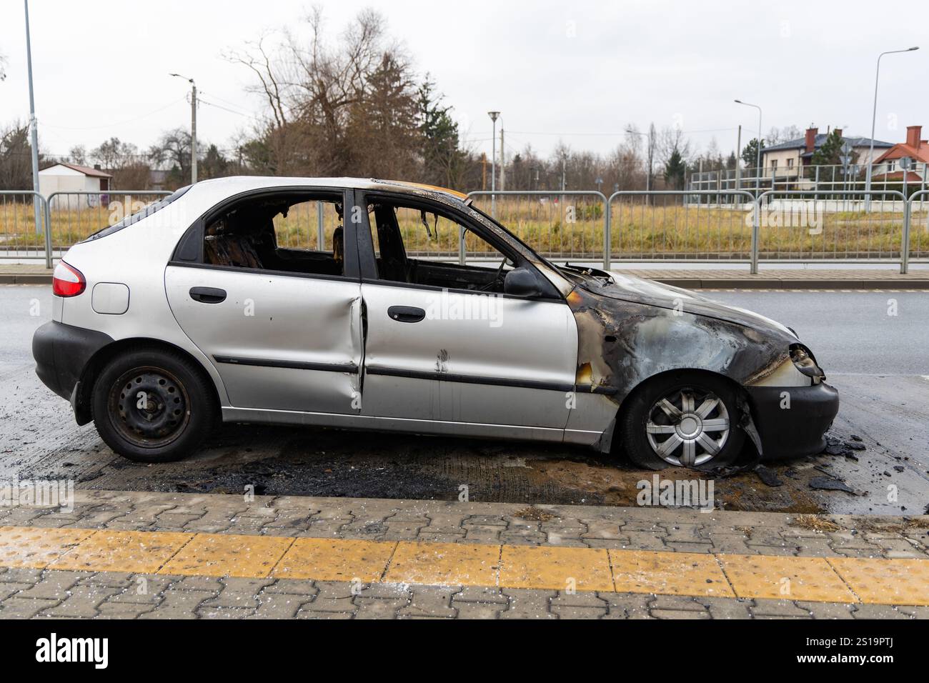 Burnt passenger car standing on the road. Vehicle with interior largely ...