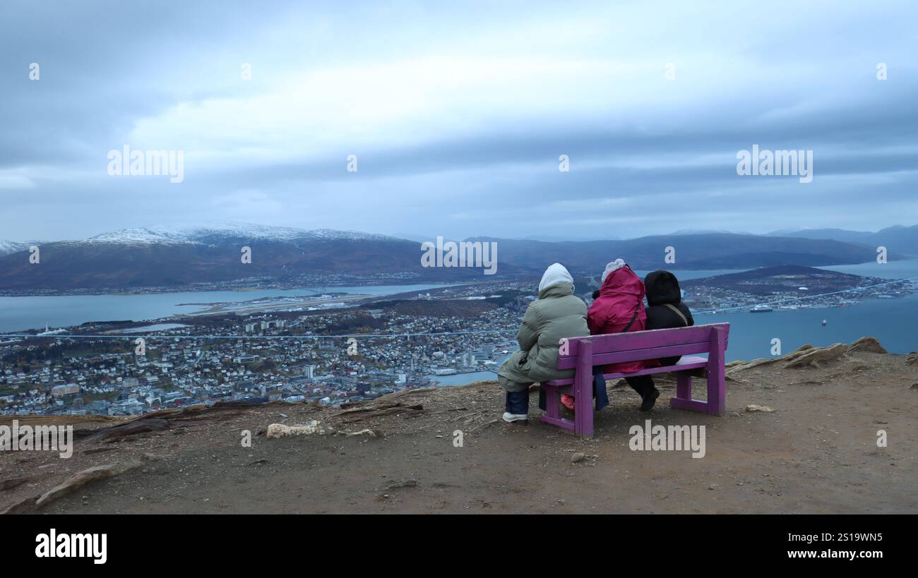 ladies sitting on a purple bench overlooking the city of Tromso, Norway ...