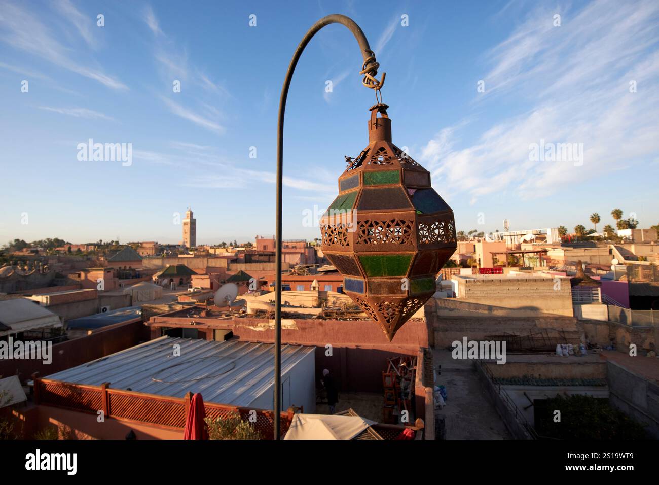 metal and glass moroccan lamp in front of cityscape rooftop view over ...
