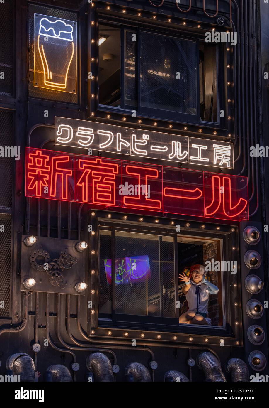 A vibrant night in Kabukicho, Shinjuku, where a cosplayer poses by the ...