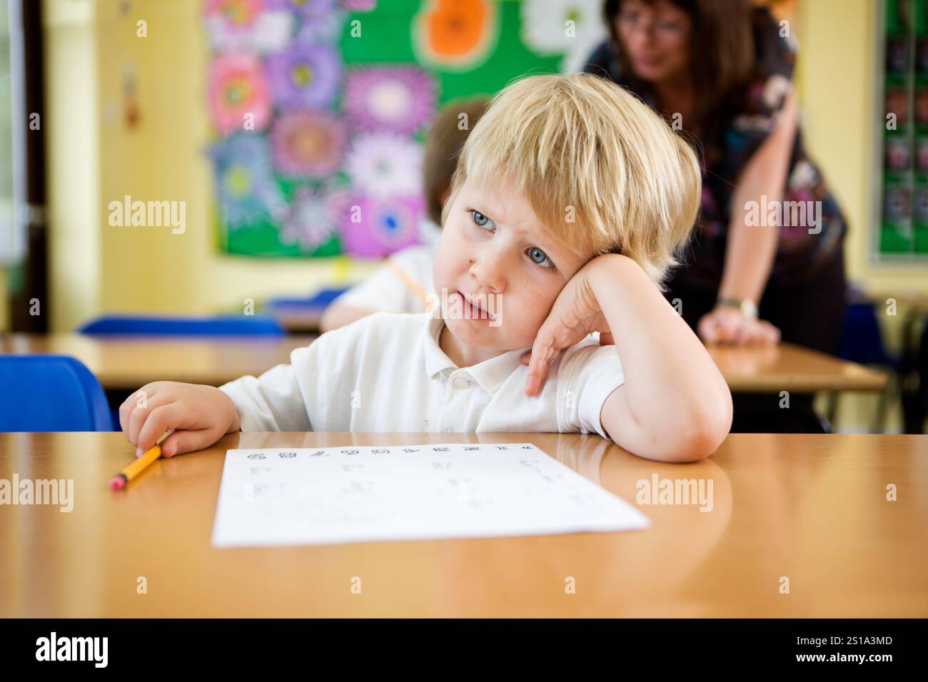 Elementary School: Primary Numbers. A thoughtful expression on the face ...