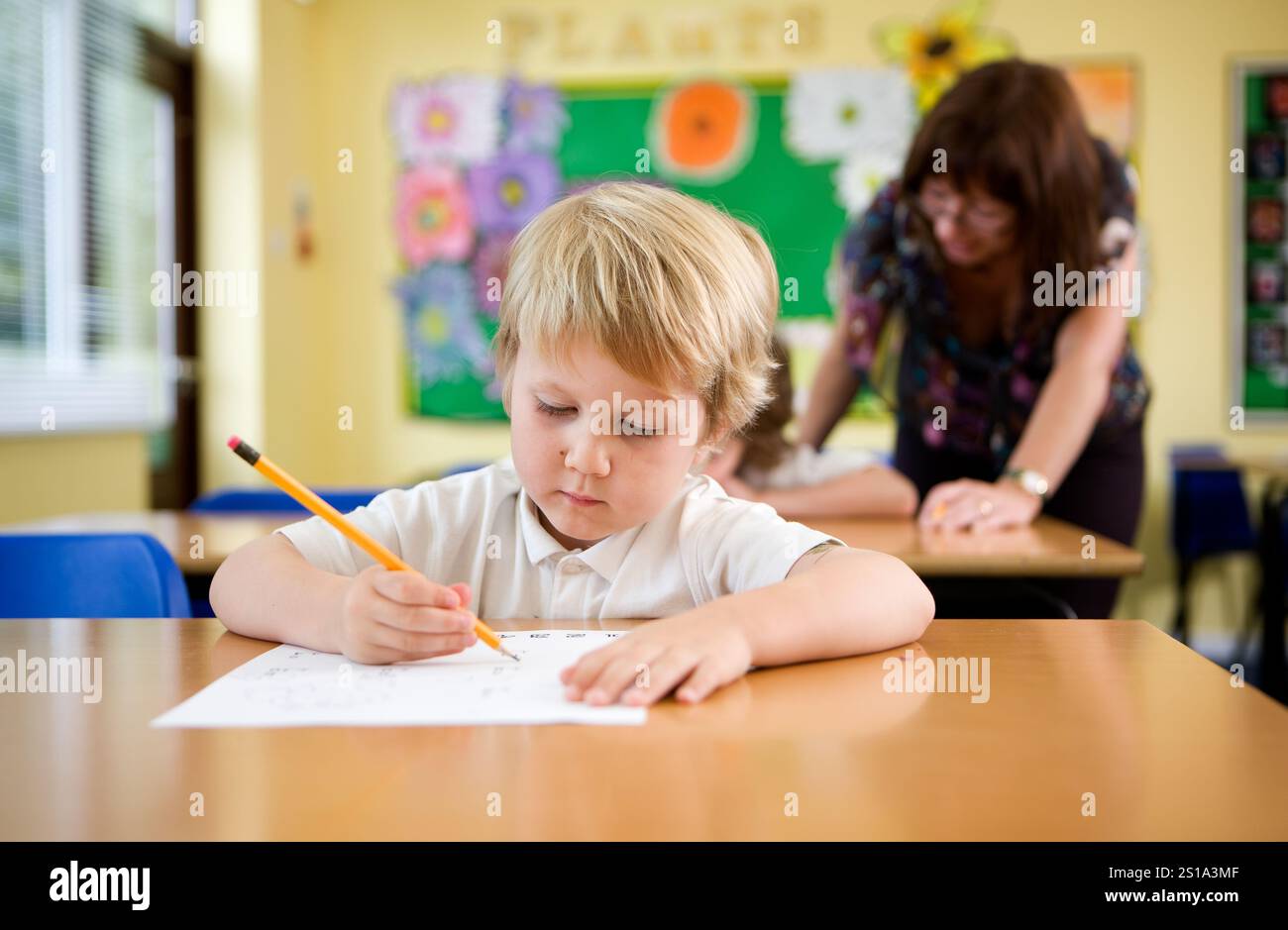 Elementary School: Problem Solving. A junior school pupil concentrating ...