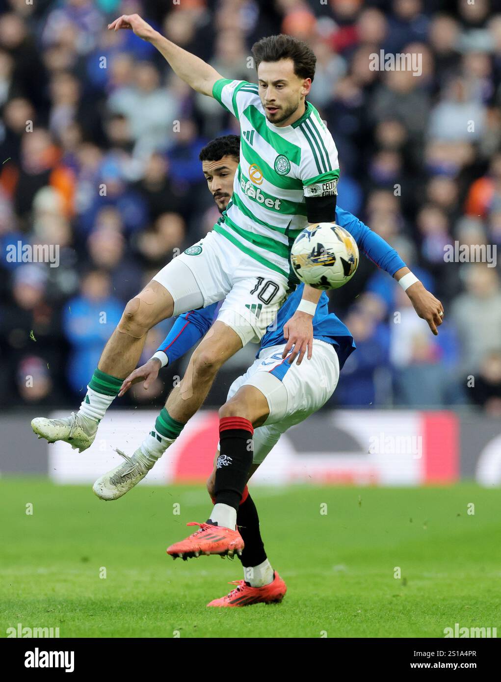 Rangers' Jefte and Celtic's Nicolas Kuhn (right) battle for the ball ...
