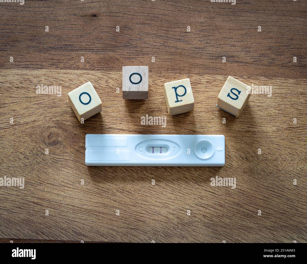 Positive Pregnancy Test with Wooden Letters Spelling Oops, A Concept of ...