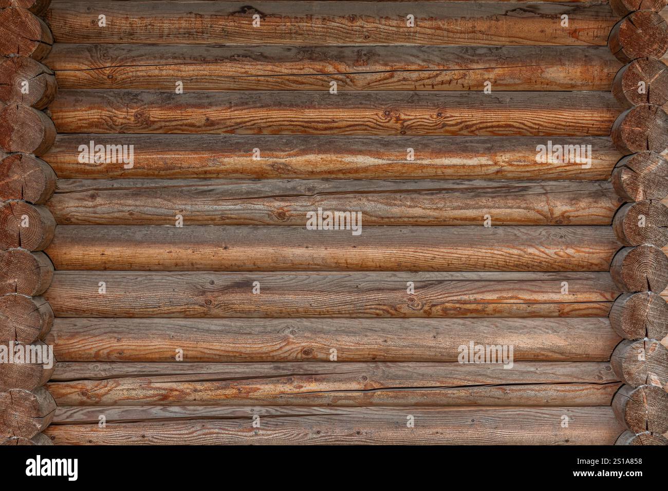 A close-up view of a log cabin wall featuring horizontally aligned ...