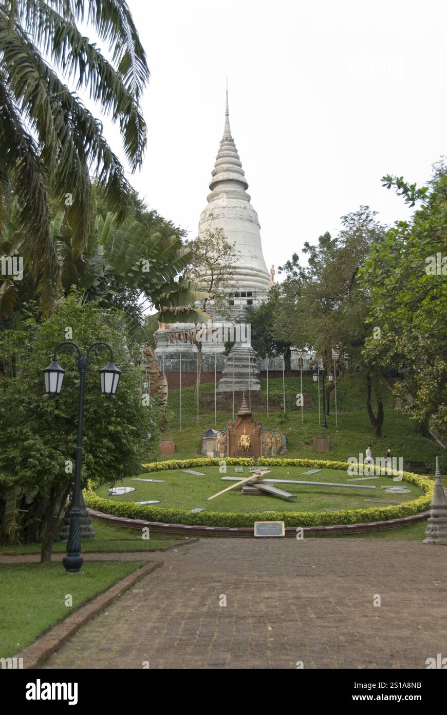 A large clock is built into a garden at Wat Phnom (Mountain Pagoda), a ...