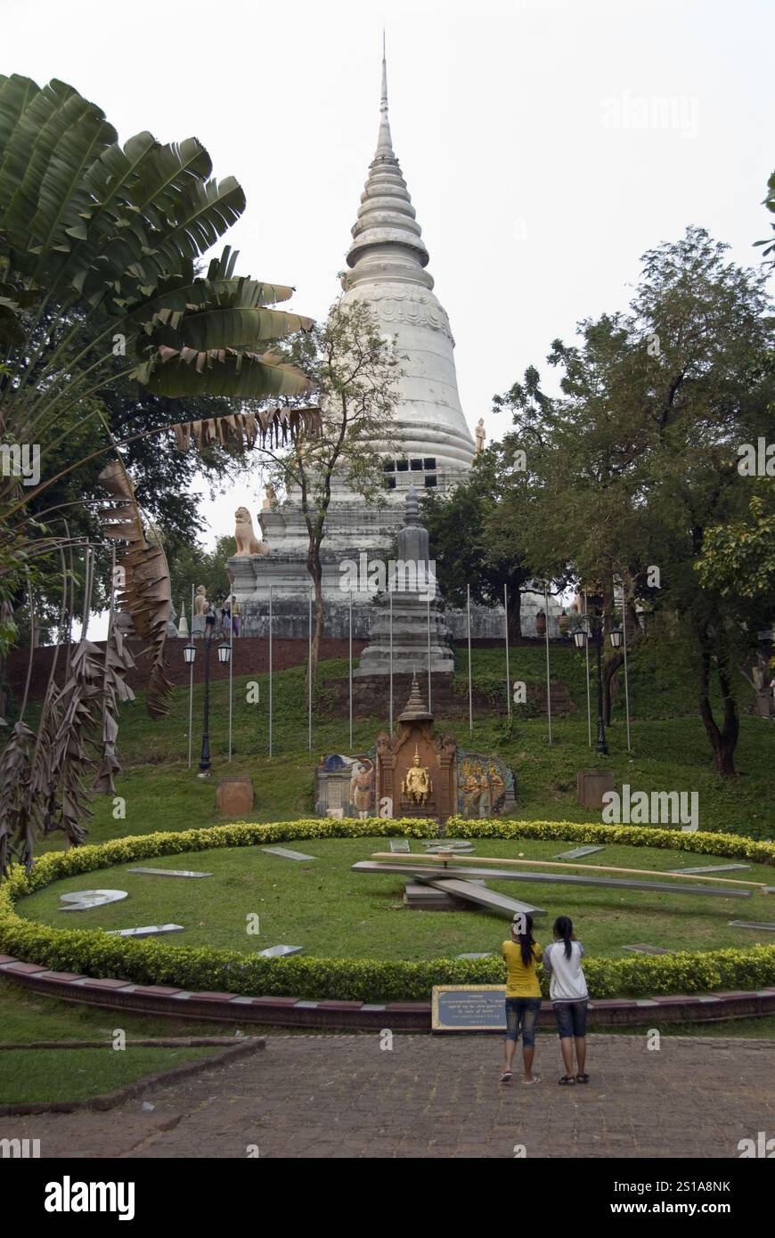 A large clock is built into a garden at Wat Phnom (Mountain Pagoda), a ...