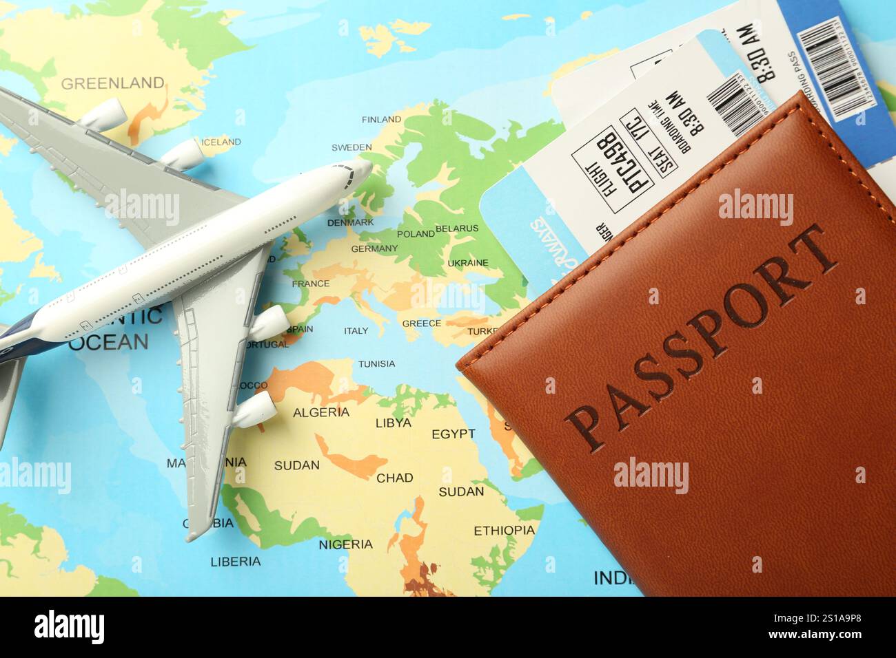Passport with tickets and plane model on world map, top view Stock ...