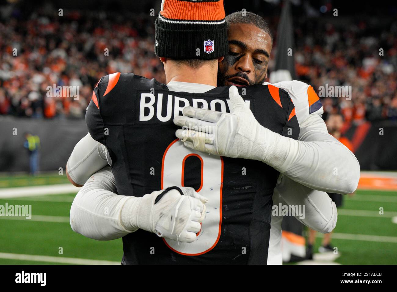 Cincinnati Bengals quarterback Joe Burrow (9) is embraced by Denver ...