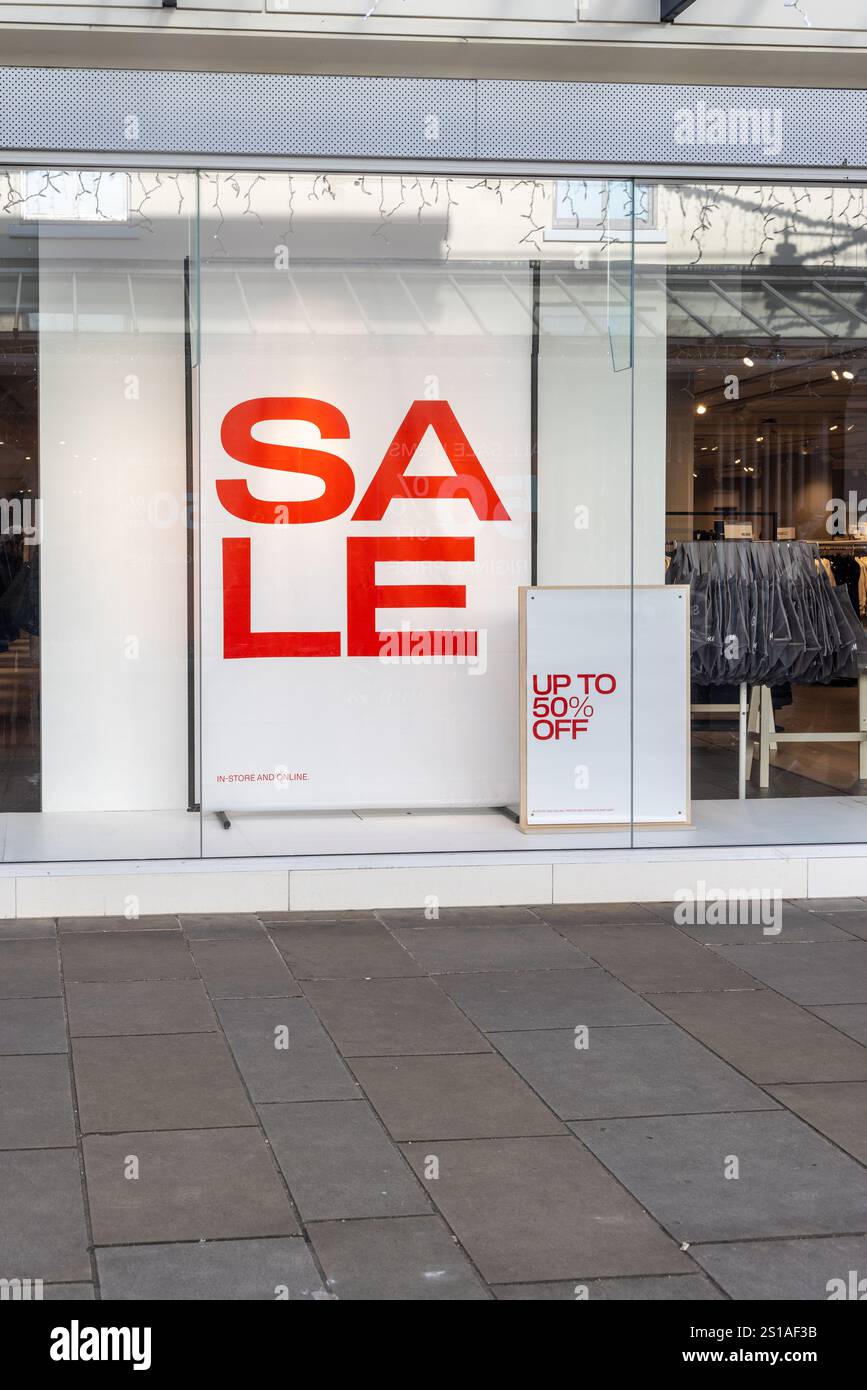 Red and white up to 50% off January Sale sign in high street shop ...