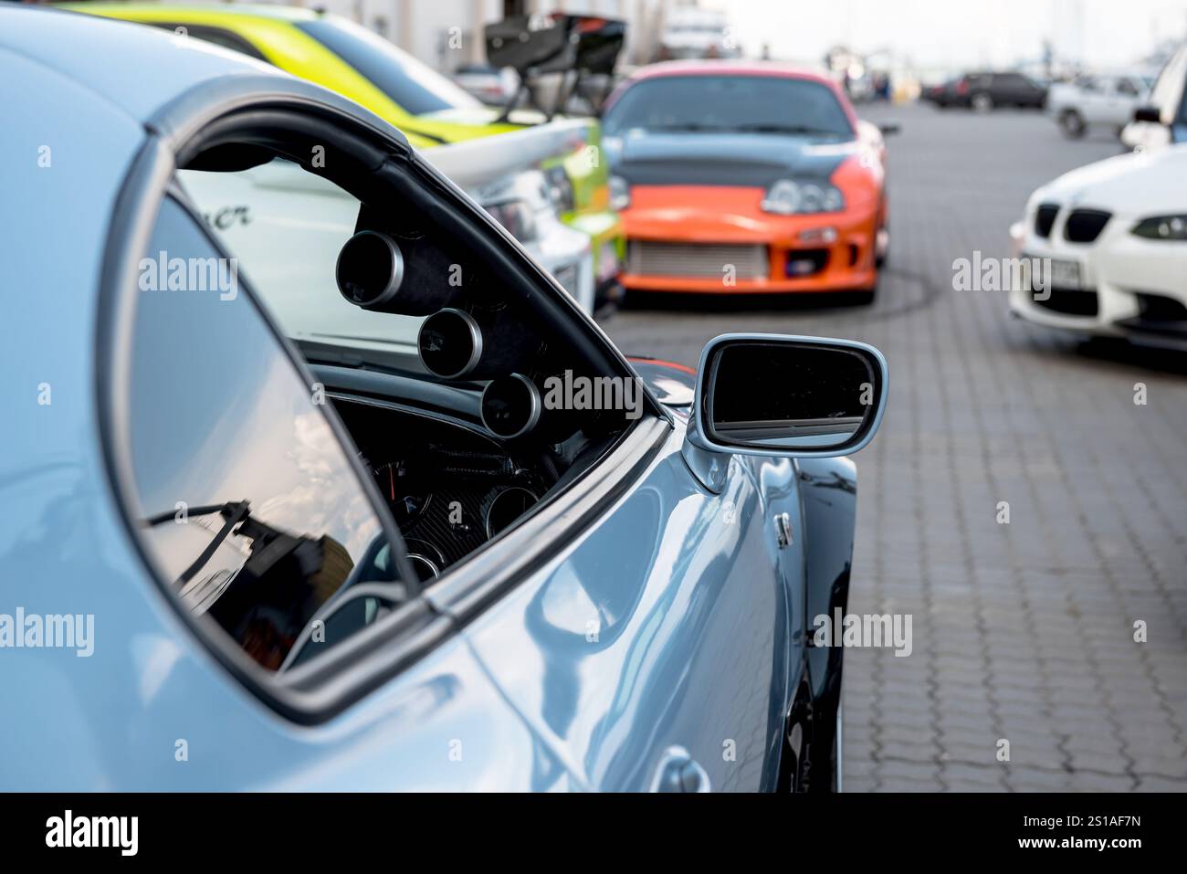 Tuned car meet - modified cars owners gathering: blue, white and orange ...