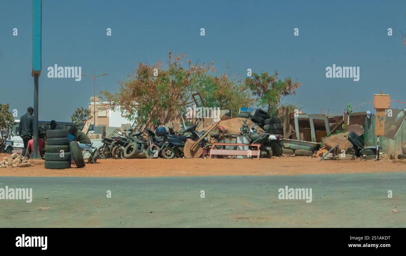 Scrap yard or repair shop with car cleaner next to a road. Typical ...