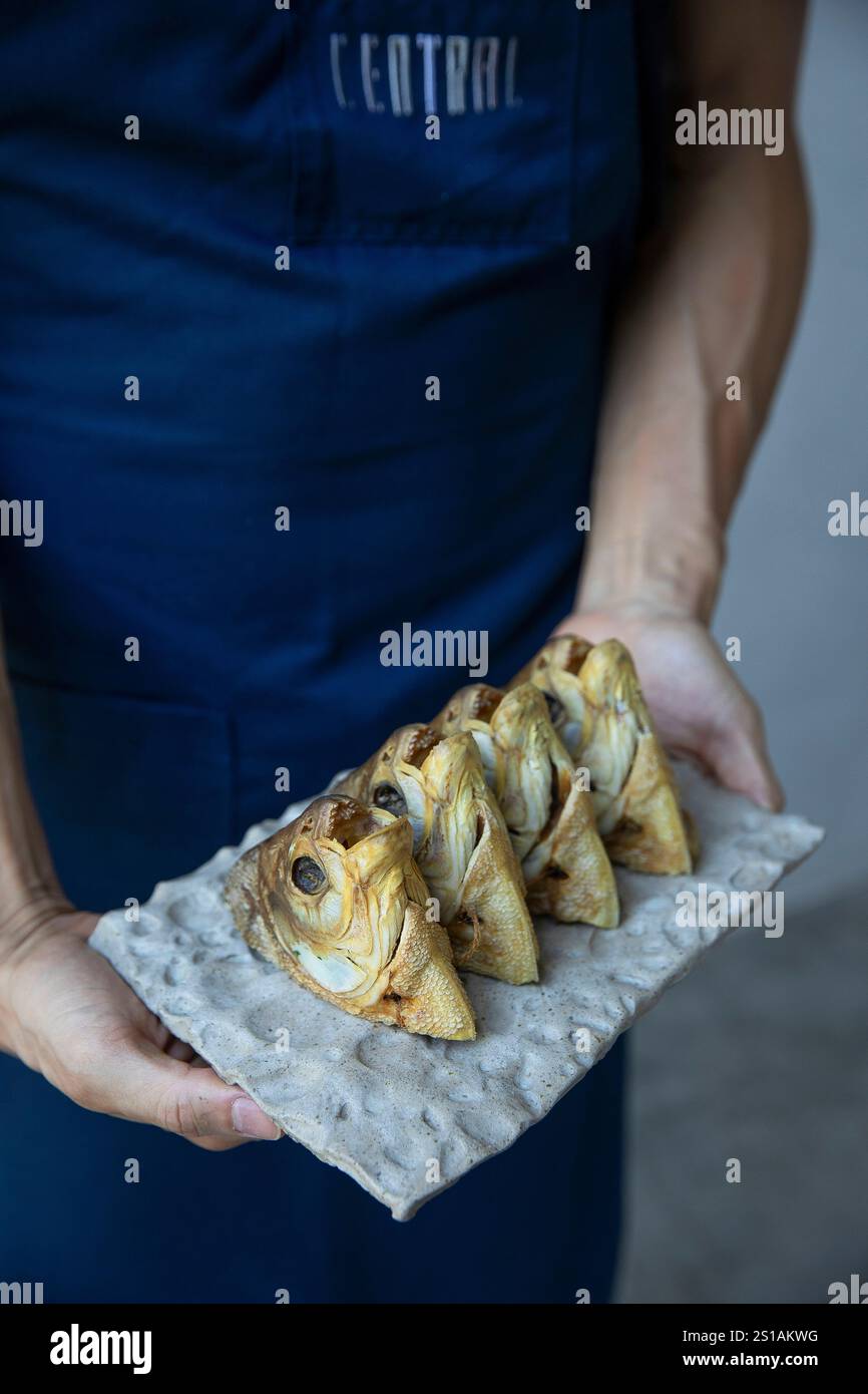 Peru, Lima, Barranco, piranha heads presented on a handcrafted plate in ...