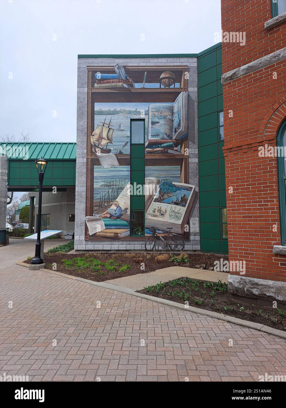 Woman reading a book in a wooden bookshelf mural on the Lauréat ...
