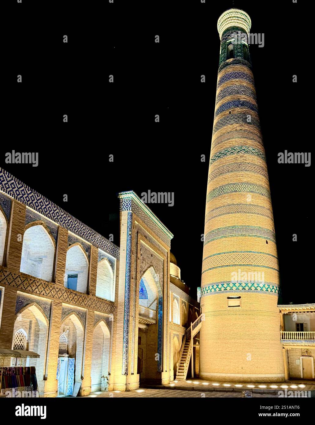 Illuminated Historic Minaret and Arched Building at Night Stock Photo ...