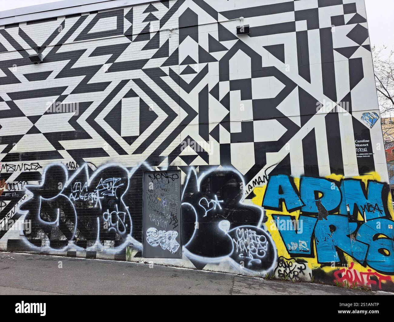 Graffiti tagged on a building in an alley near Saint-Laurent Boulevard ...