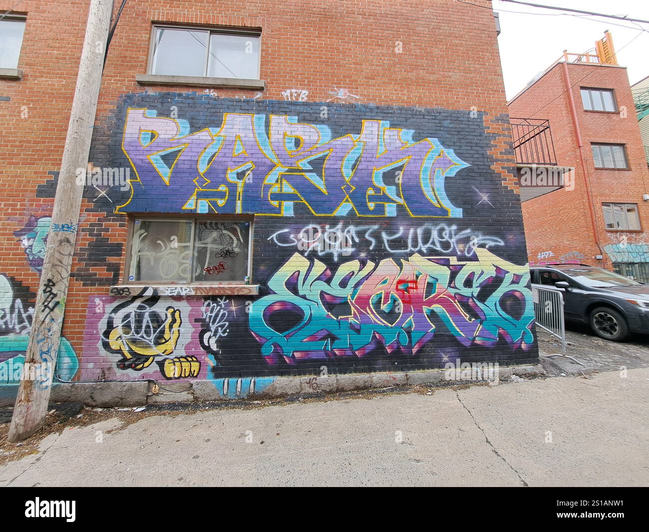 Graffiti tagged on a building in an alley near Saint-Laurent Boulevard ...