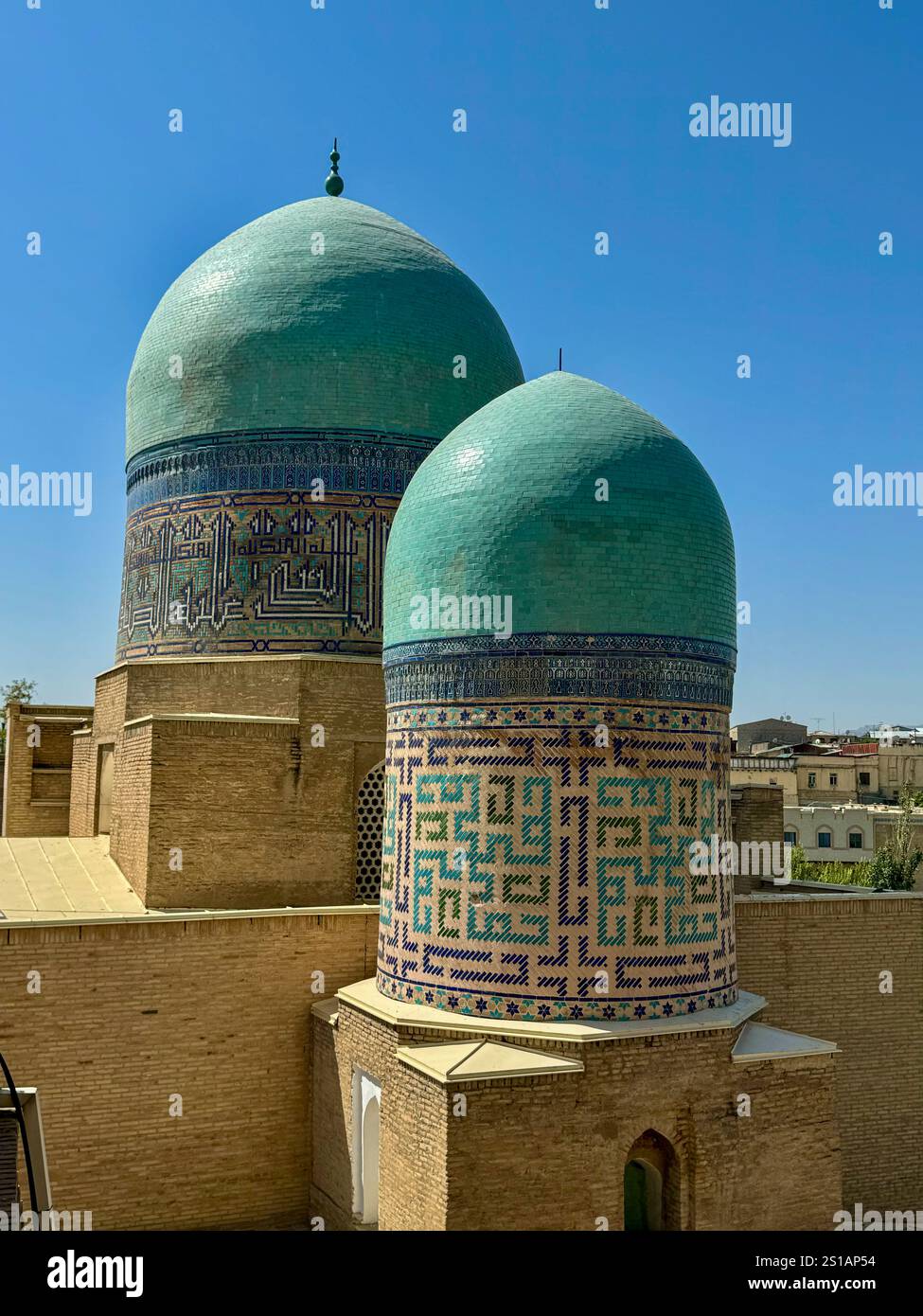 Blue-tiled domes of a historic mosque in Central Asia under clear sky ...
