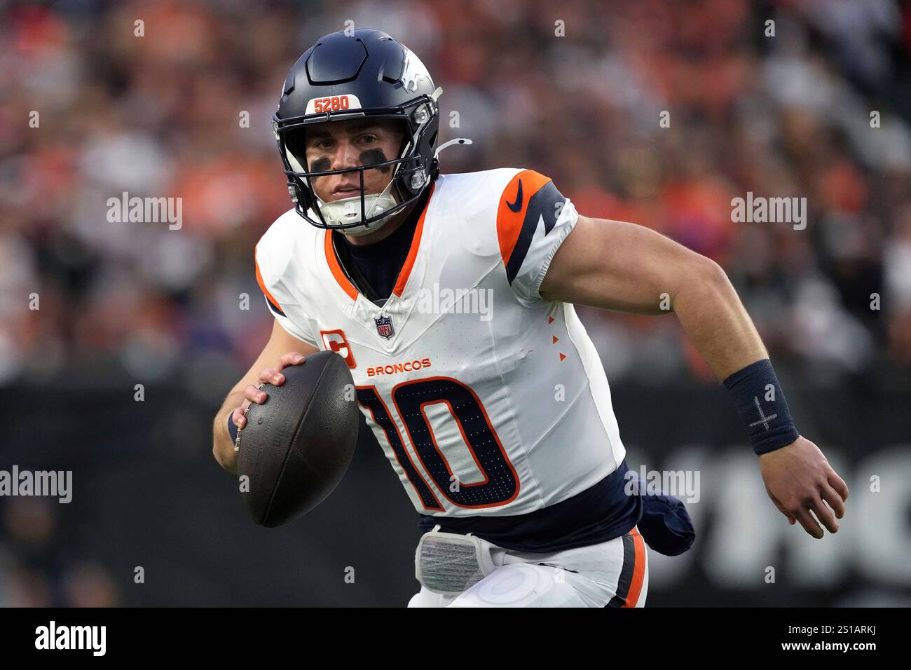 Denver Broncos quarterback Bo Nix runs during the first half of an NFL ...