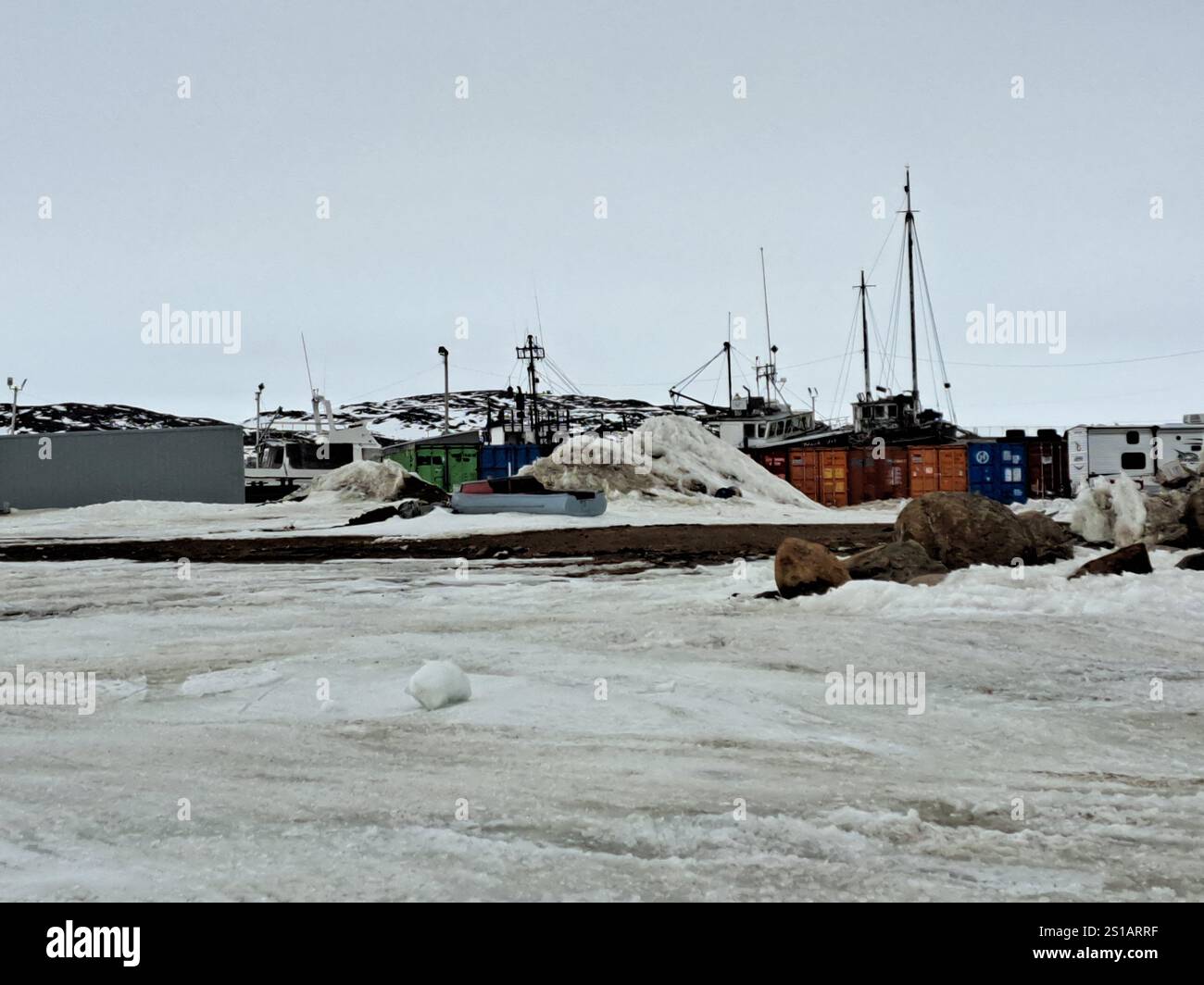 Storage of various boats and equipment at the beach on Frobisher Bay in Iqaluit, Nunavut, Canada ...