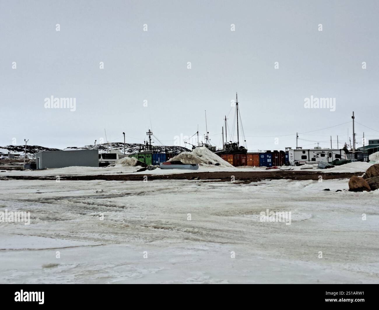 Storage of various boats and equipment at the beach on Frobisher Bay in Iqaluit, Nunavut, Canada ...