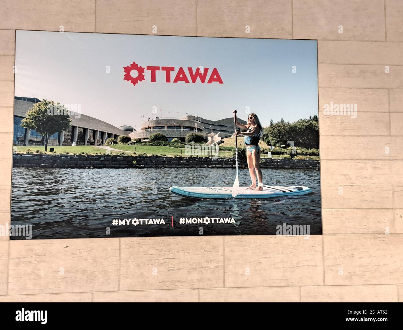 My Ottawa sign with a woman paddle boarding on the river at the Ottawa ...