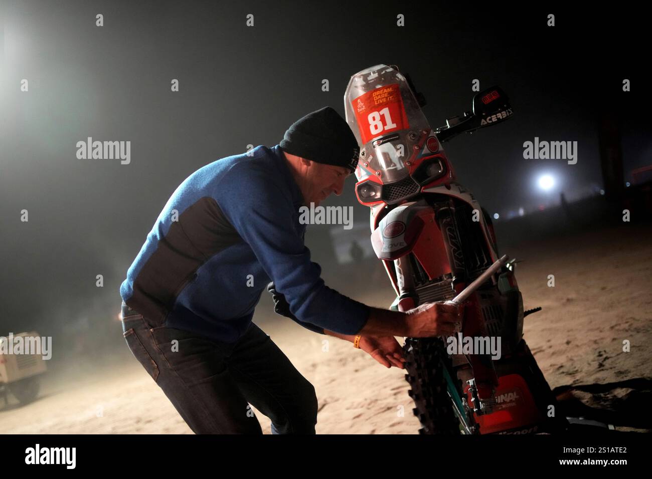 Cesare Zacchetti of Team Kove fixes the wheel of his motorbike on the ...