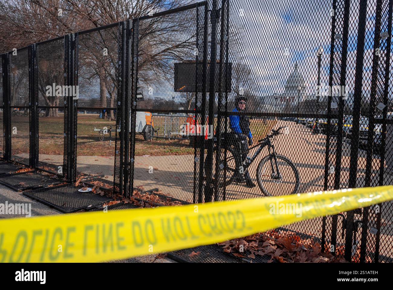 A U.S. Capitol Police Officer stands with her bicycle next to security ...