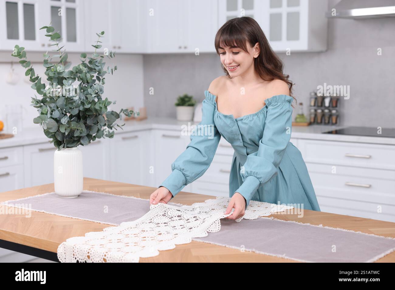 Woman setting table for dinner at home Stock Photo - Alamy