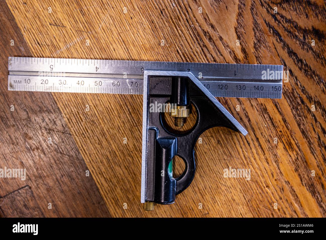 A small combination square with both inches and millimeters Stock Photo ...