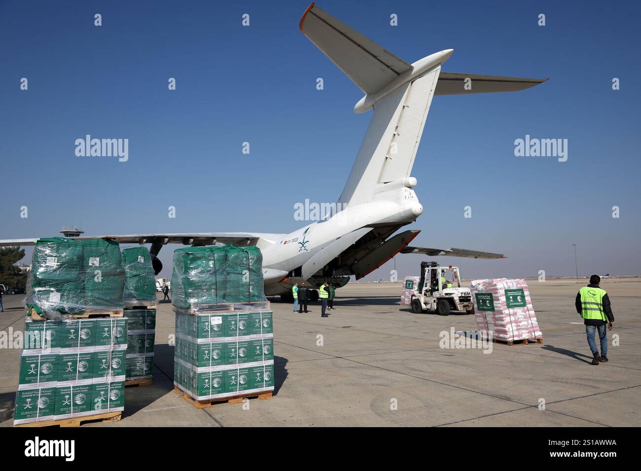 Workers unload humanitarian aid, from Saudi Arabia plane at Damascus ...