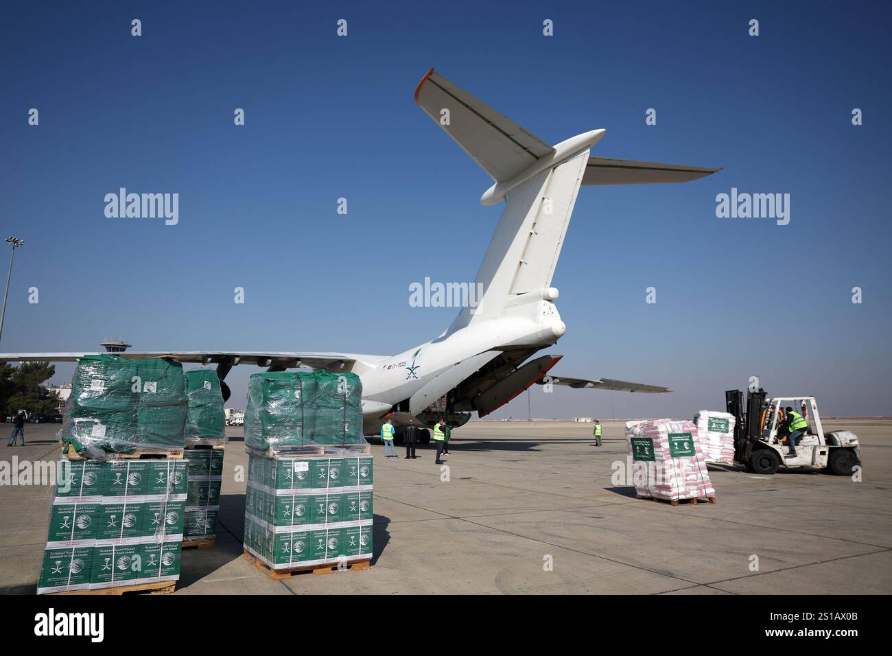 Workers unload humanitarian aid, from Saudi Arabia plane at Damascus ...