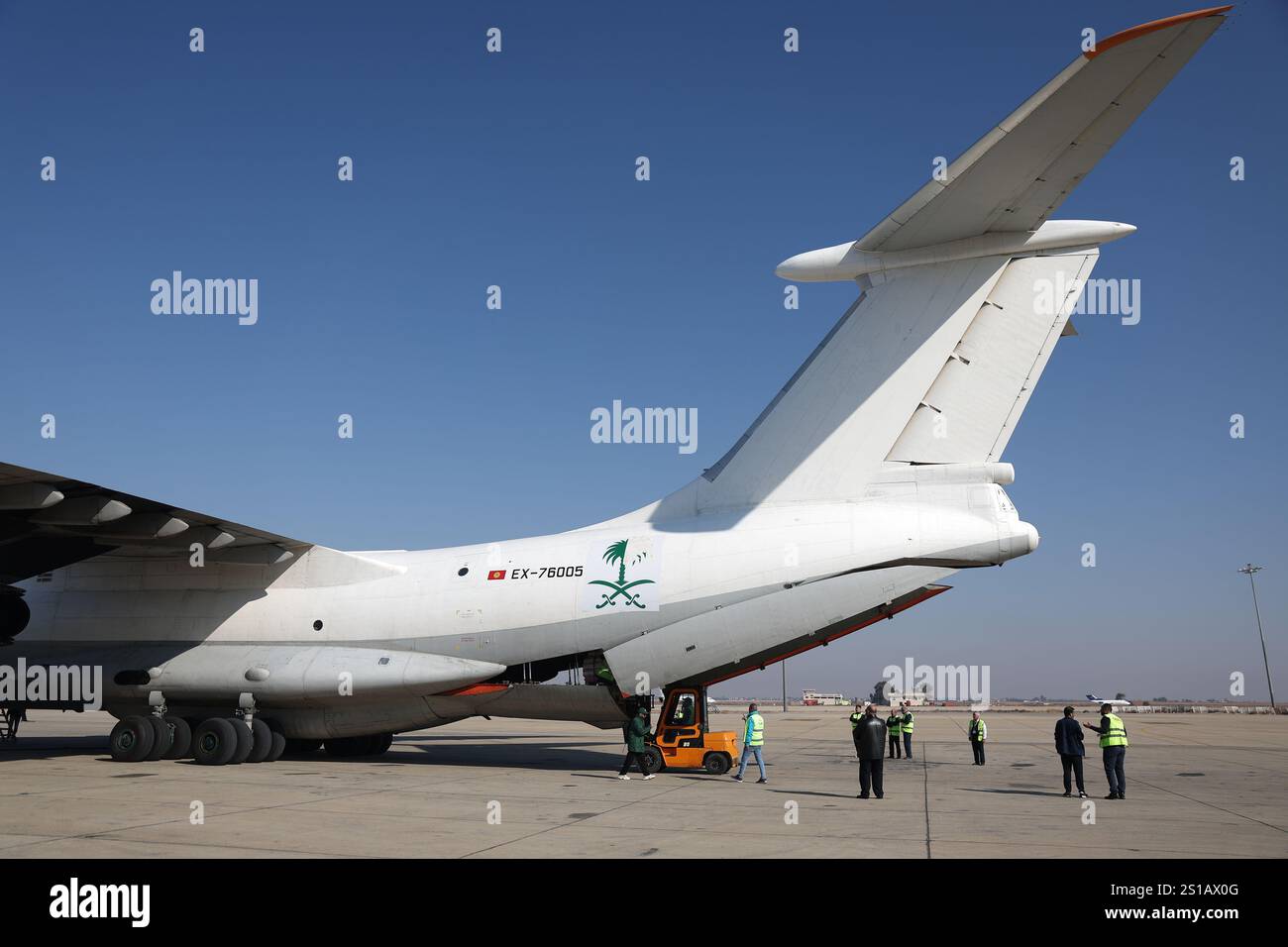 Workers unload humanitarian aid, from Saudi Arabia plane at Damascus ...