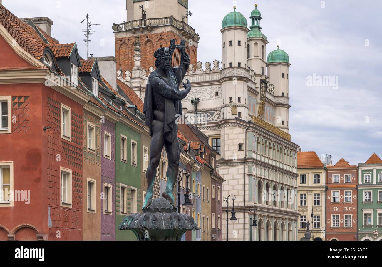 Colorful buildings frame the historic Town Hall, where a statue stands ...