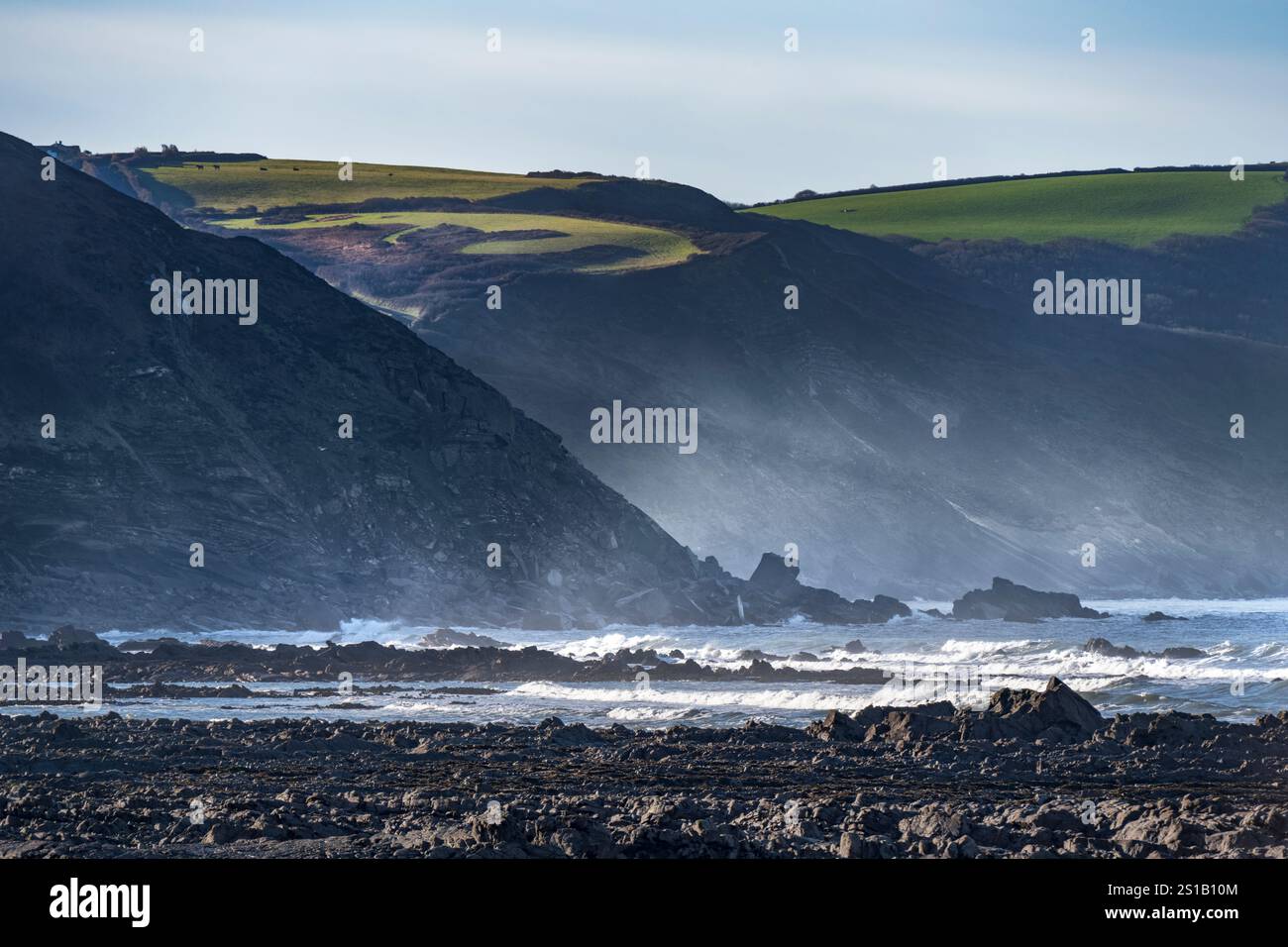 Sea mist rising from early morning surf at Widemouth Bay in early ...