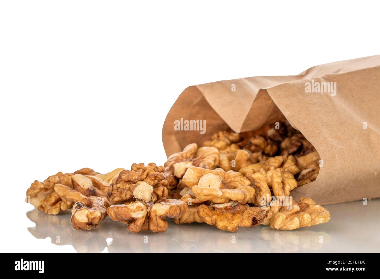 Shelled walnuts with paper bag, close-up, isolated on white background ...