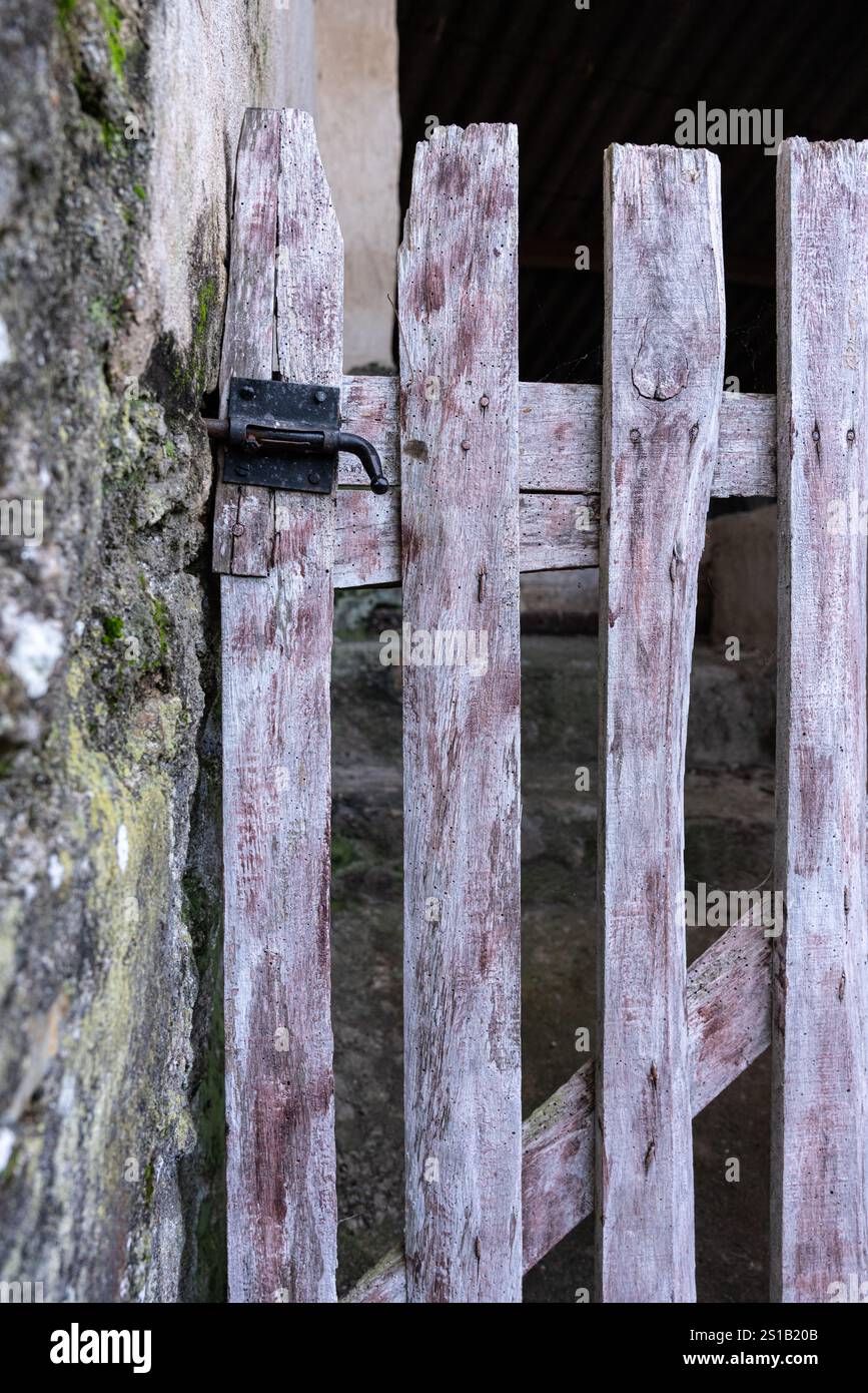 A wooden gate with a metal lock. The gate is closed Stock Photo - Alamy