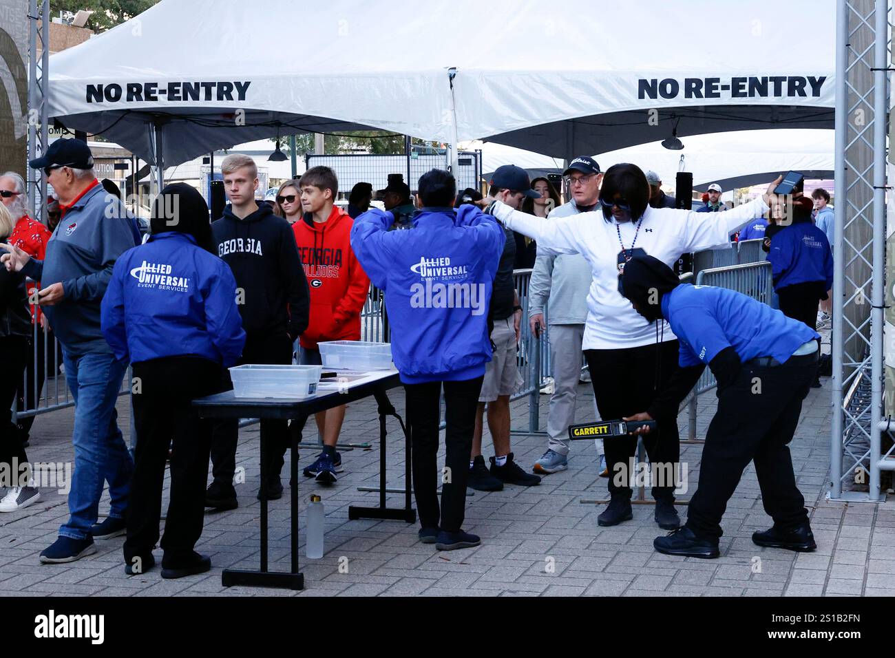 Fans pass through security check points as they enter the Caesars ...