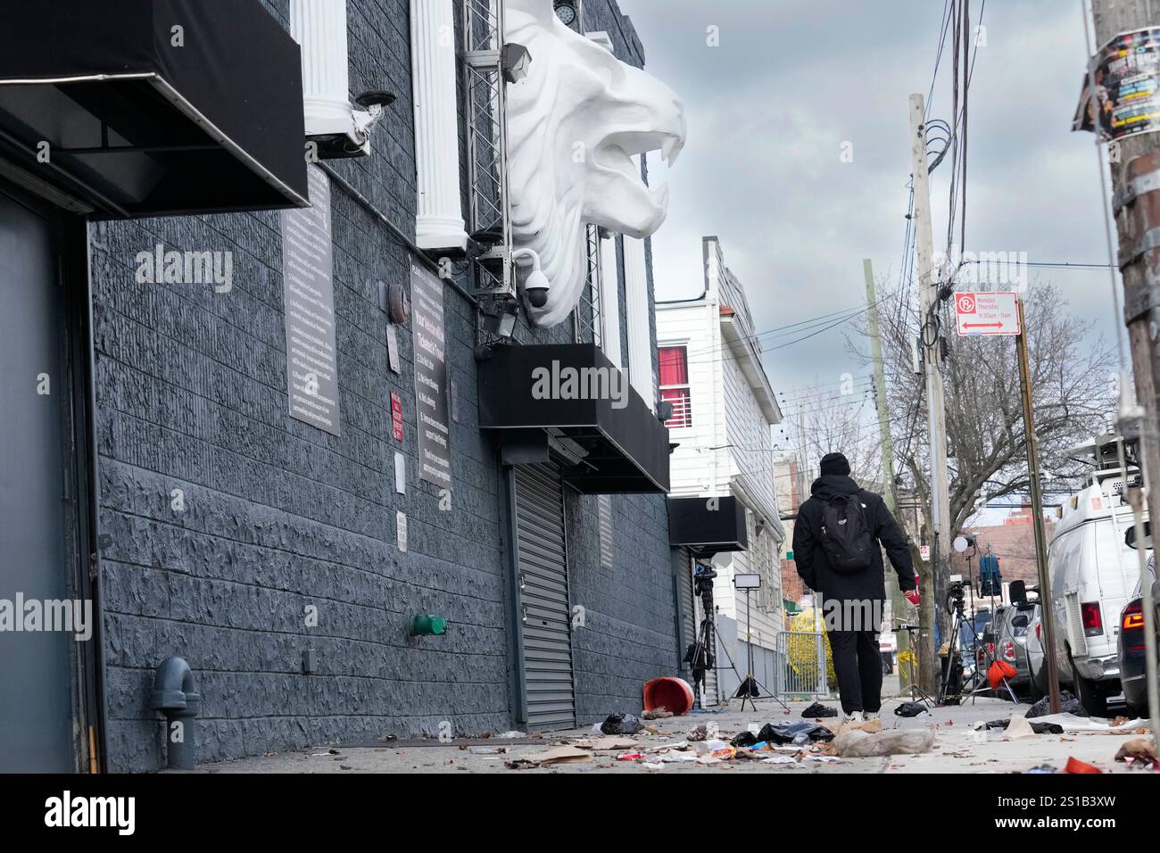Members of the media work in front of the nightclub Amazura, left, in ...