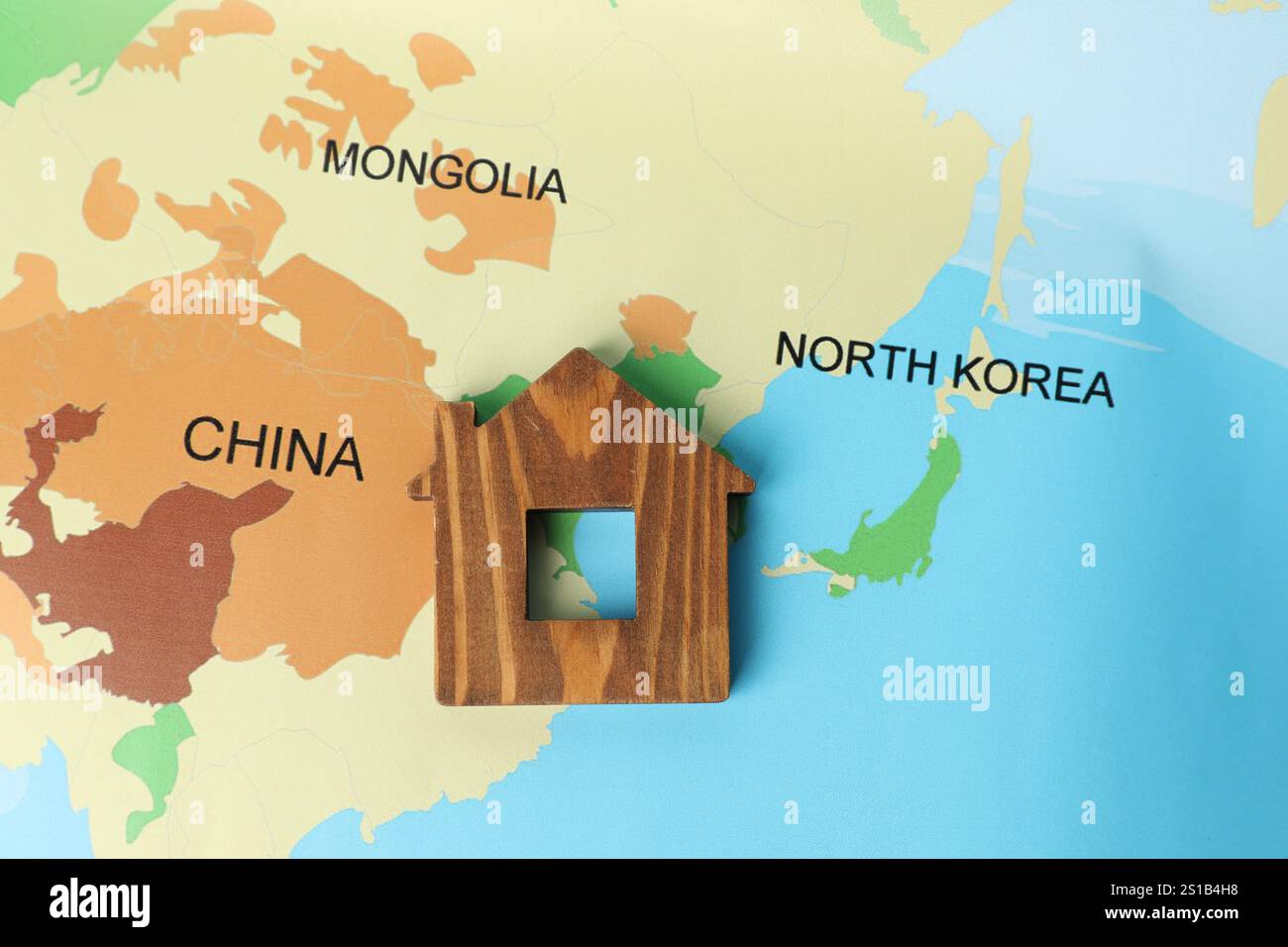 Wooden house model on world map, top view. Accommodation search Stock ...