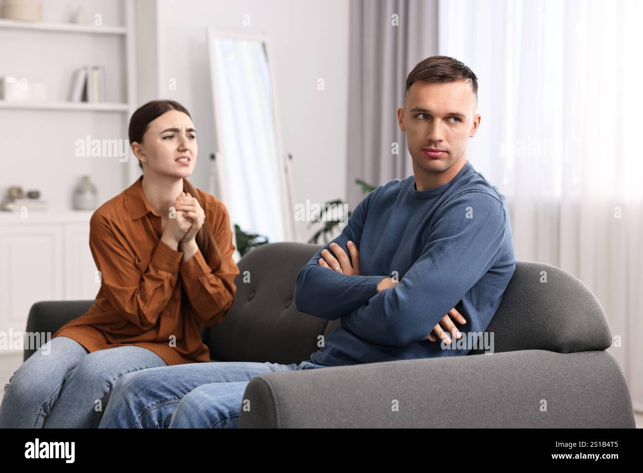 Wife apologizing her husband while he ignoring her at home Stock Photo ...