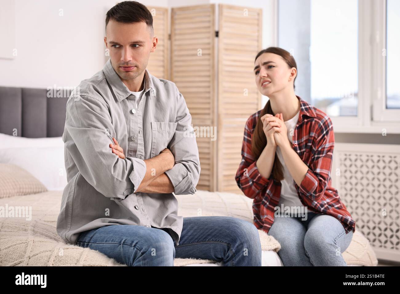 Wife apologizing her husband while he ignoring her at home Stock Photo ...