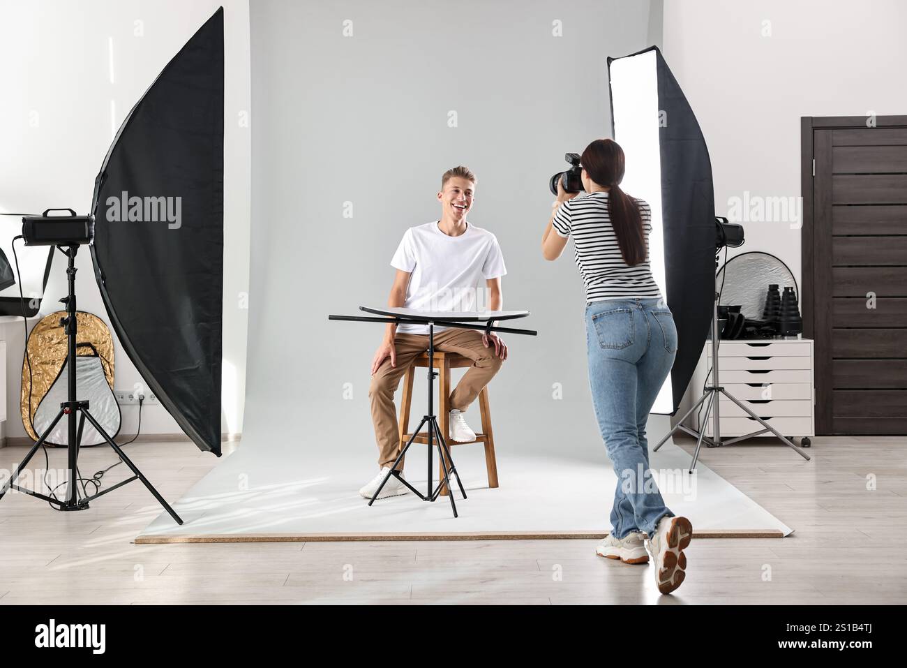 Photographer working with model in professional photo studio Stock ...