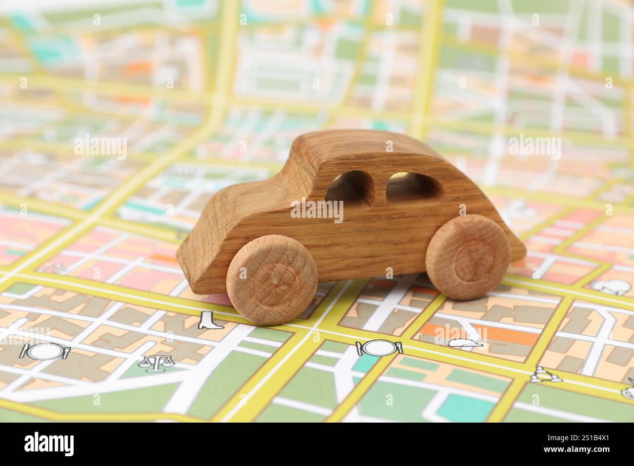 Wooden toy car on city map. Road trip Stock Photo - Alamy